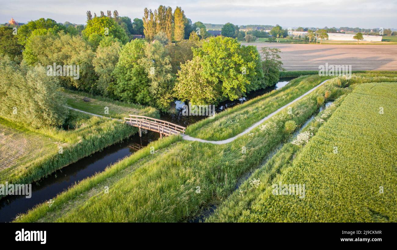 Little small bridge crossing water canal in Dutch countryside ...