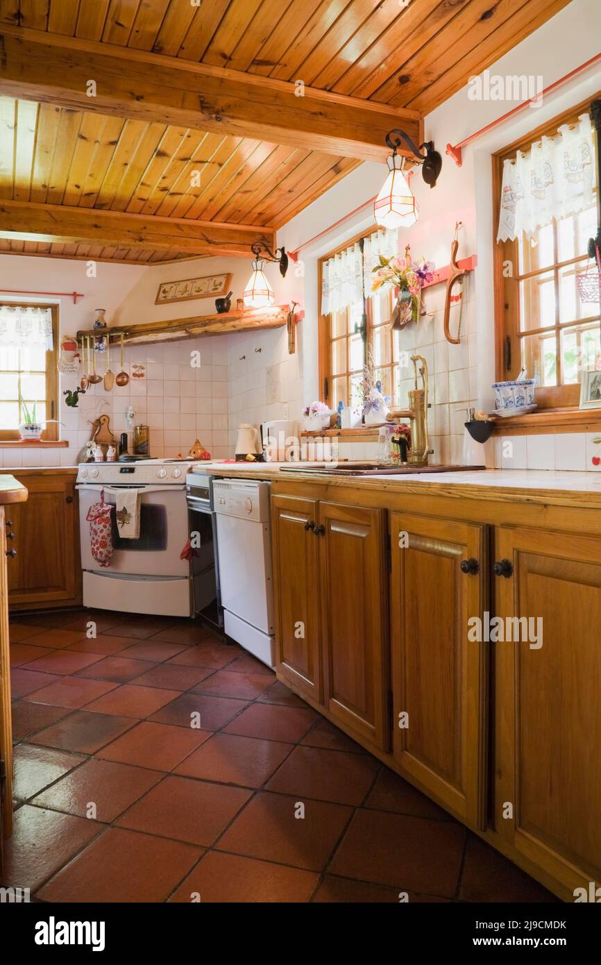 Stove and counters in kitchen with terracotta ceramic tile floor inside ...