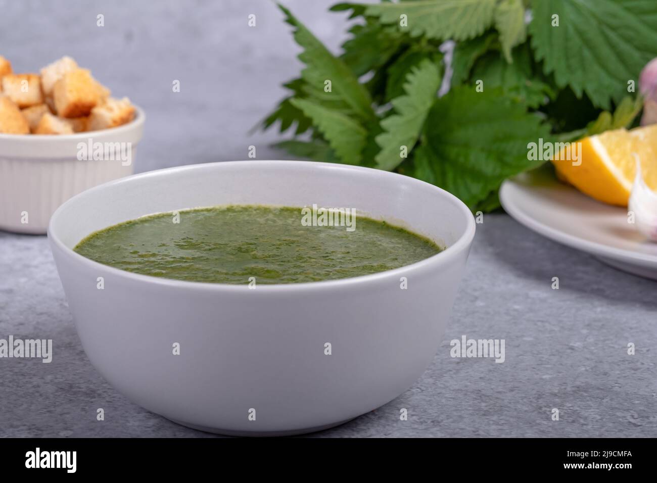 Spring nettle soup and wild, onion, lemon and bread Stock Photo - Alamy
