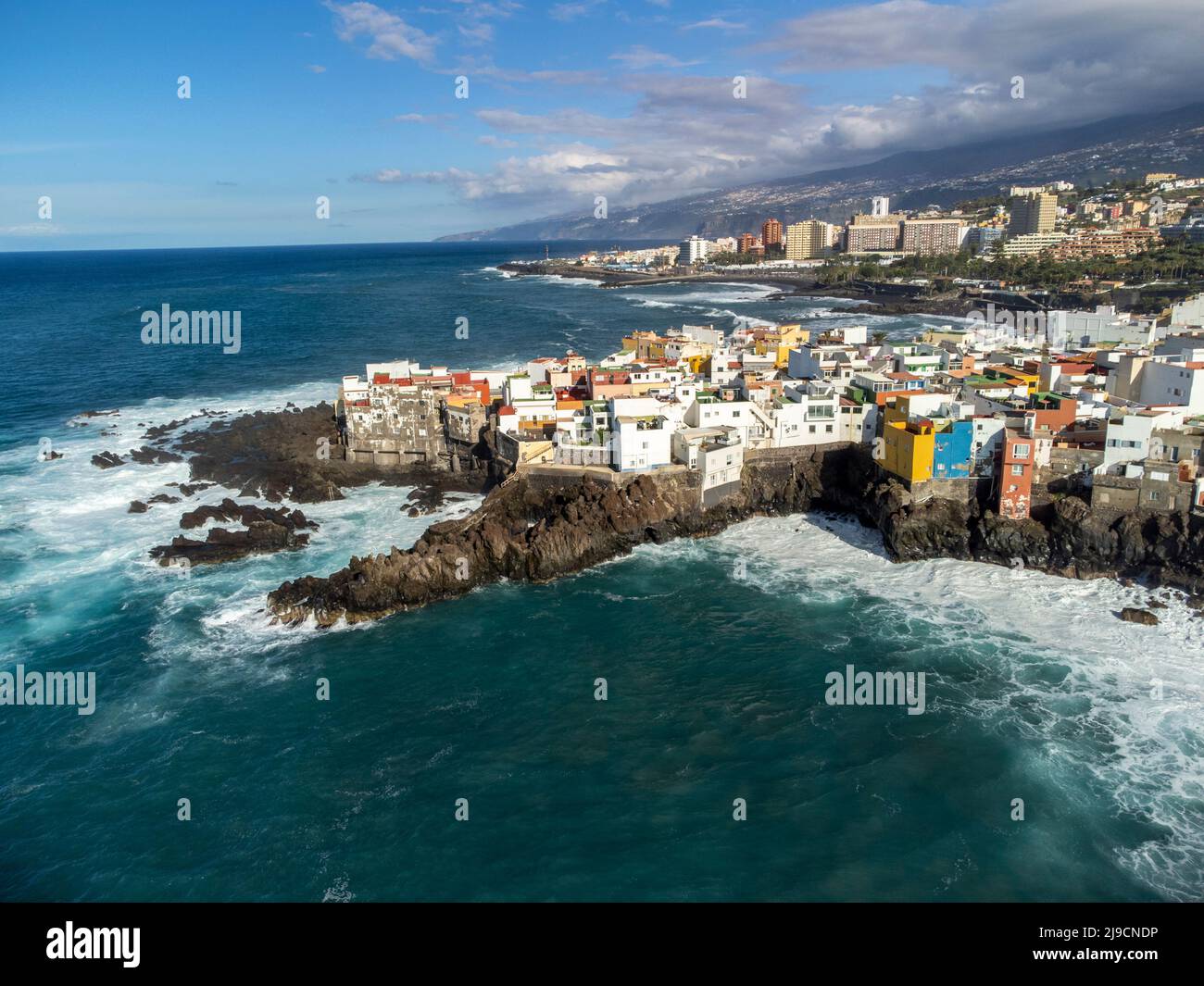 Aerial view on colorful houses and black lava rocks in small fisherman ...