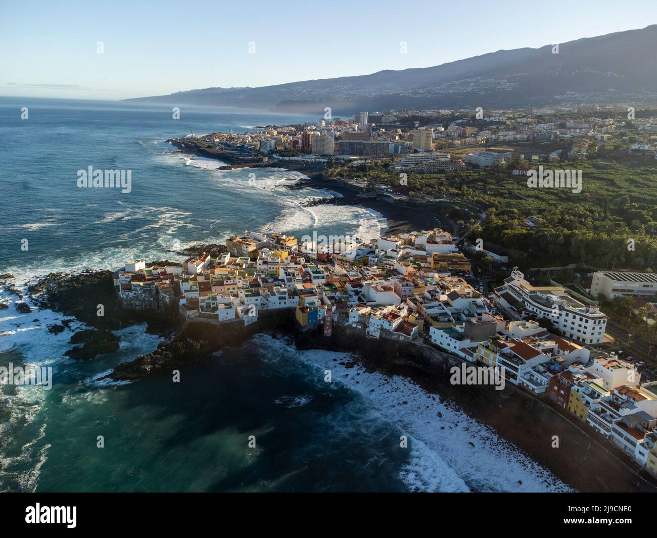 Aerial view on colorful houses and black lava rocks in small fisherman ...