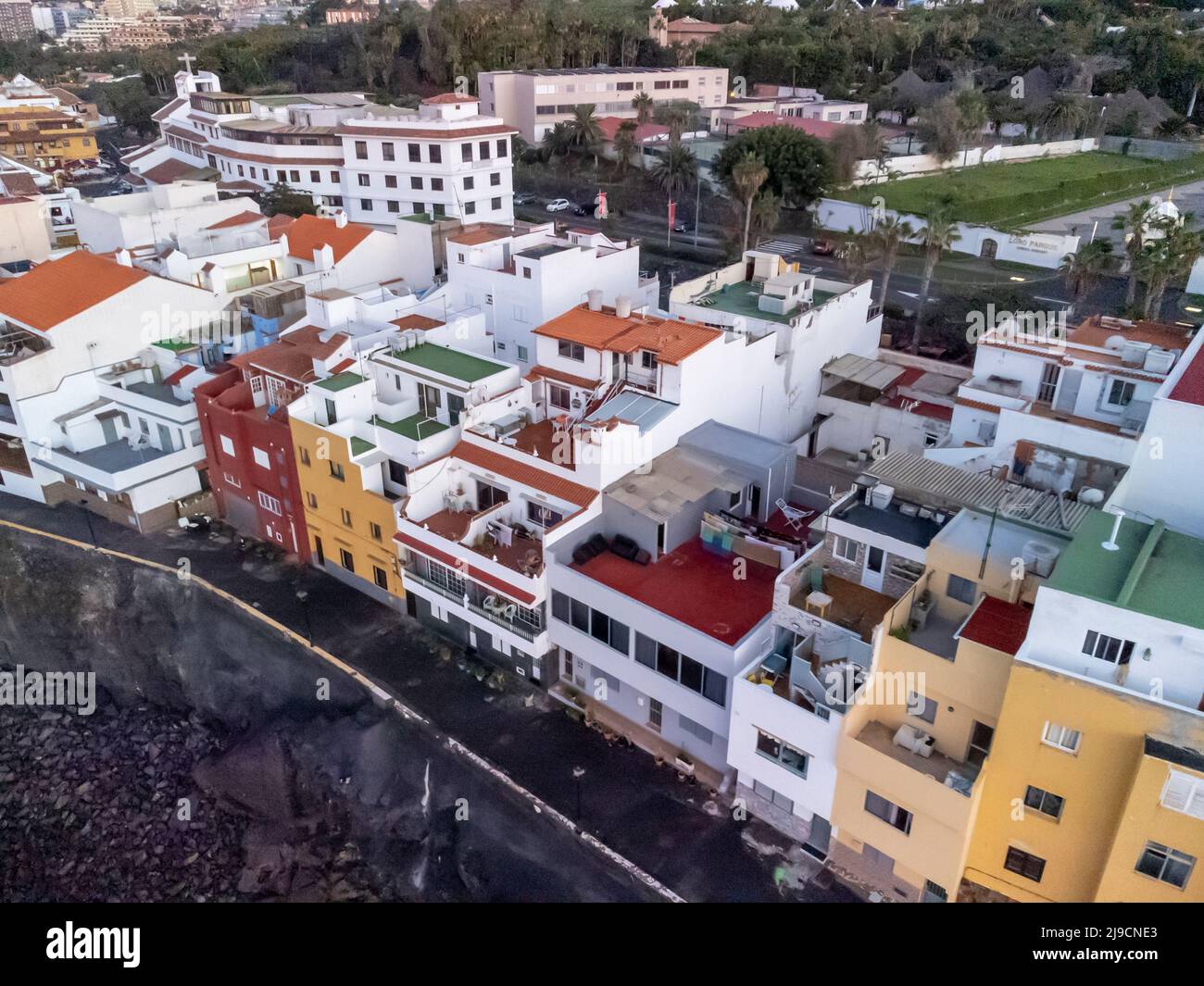 Aerial view on colorful houses and black lava rocks in small fisherman ...