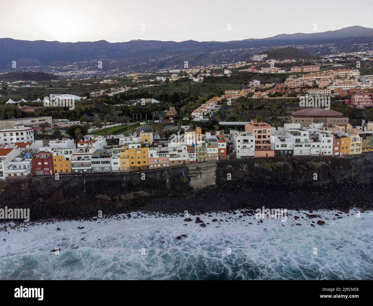 Aerial view on colorful houses and black lava rocks in small fisherman ...