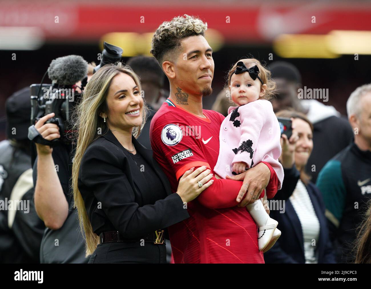 Liverpool's Roberto Firmino walks the pitch with his family after the ...