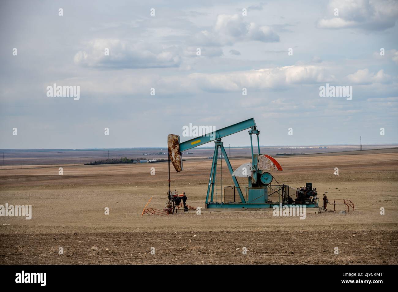 Pumpjacks working in the oil fields of Alberta on a spring day Stock ...