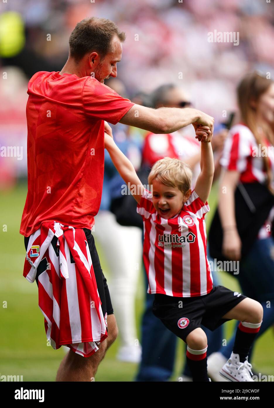 Brentford's Christian Eriksen with his son during a lap on honour after ...