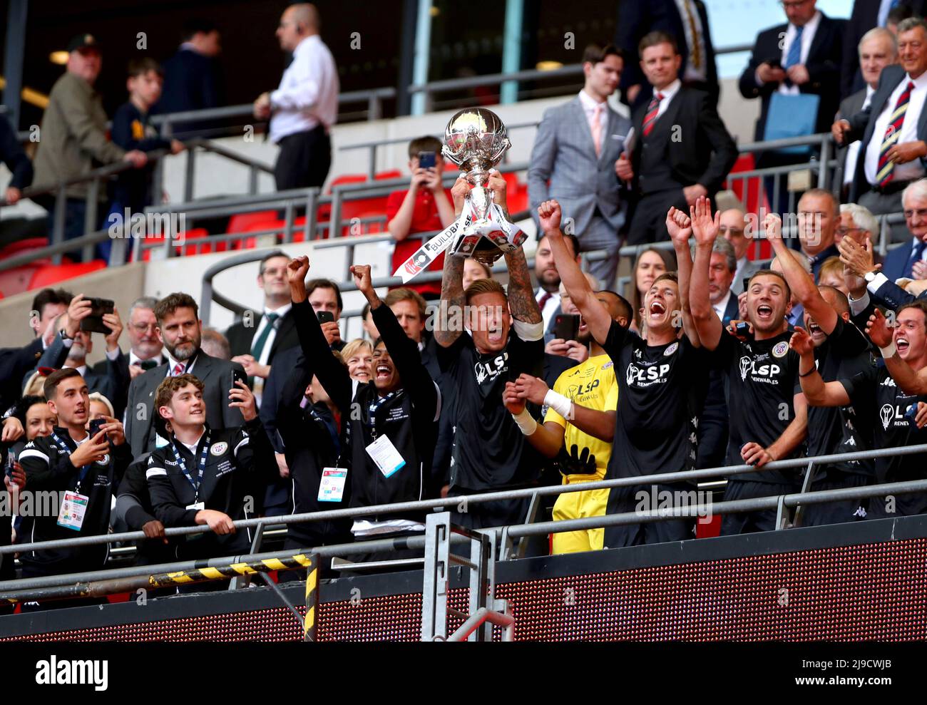 Bromley players lift the trophy as they celebrate winning the Buildbase ...