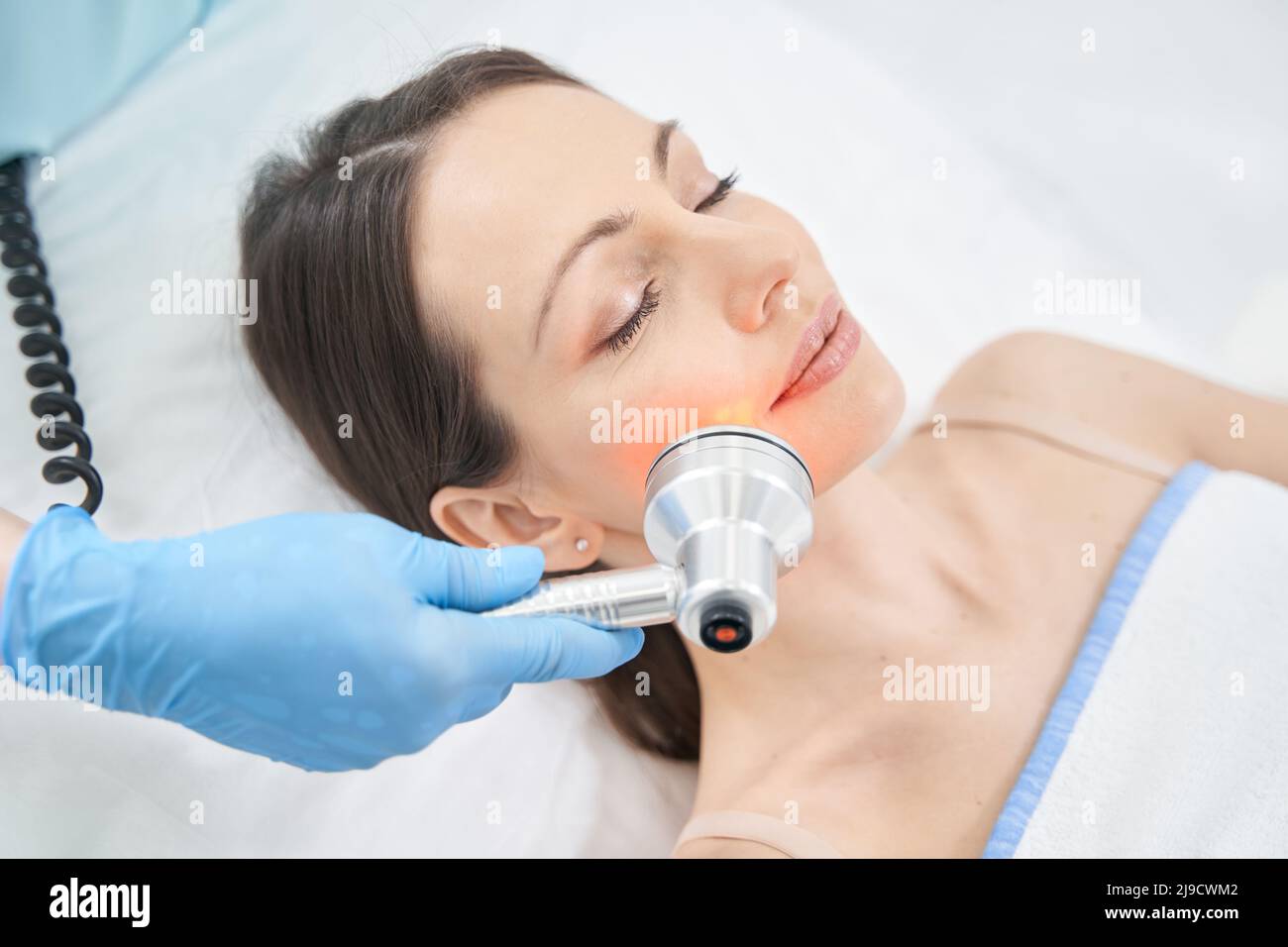 Adult woman having face lifting procedure in beauty center Stock Photo ...