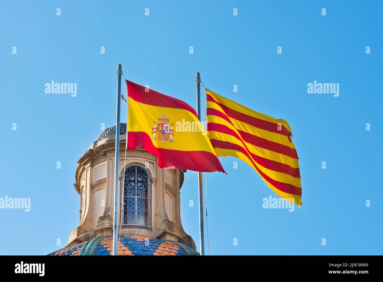 Flags of Spain and the autonomous community of Catalonia waving in the ...