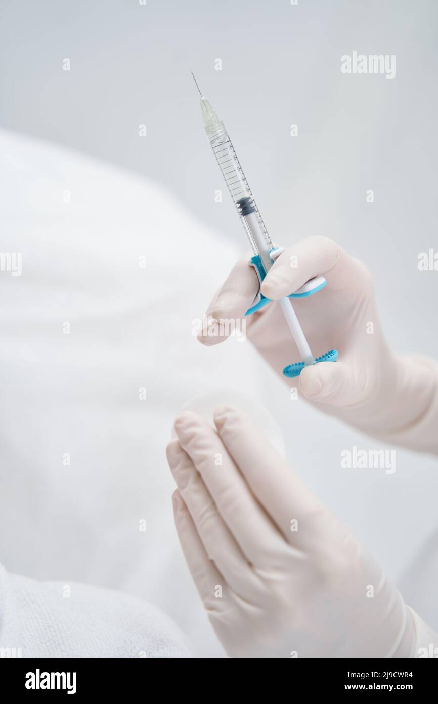 Female doctor hands holding medical syringe with needle Stock Photo - Alamy
