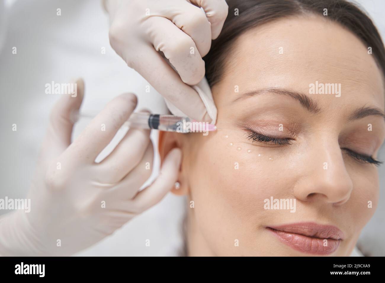 Doctor beautician doing contour plastic injection into woman face Stock ...