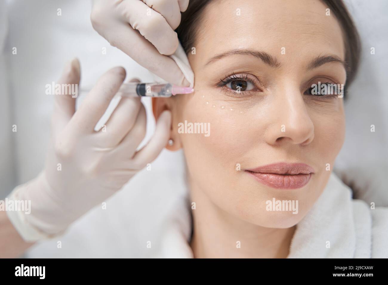 Cosmetologist doing contour plastic injection into woman face Stock ...