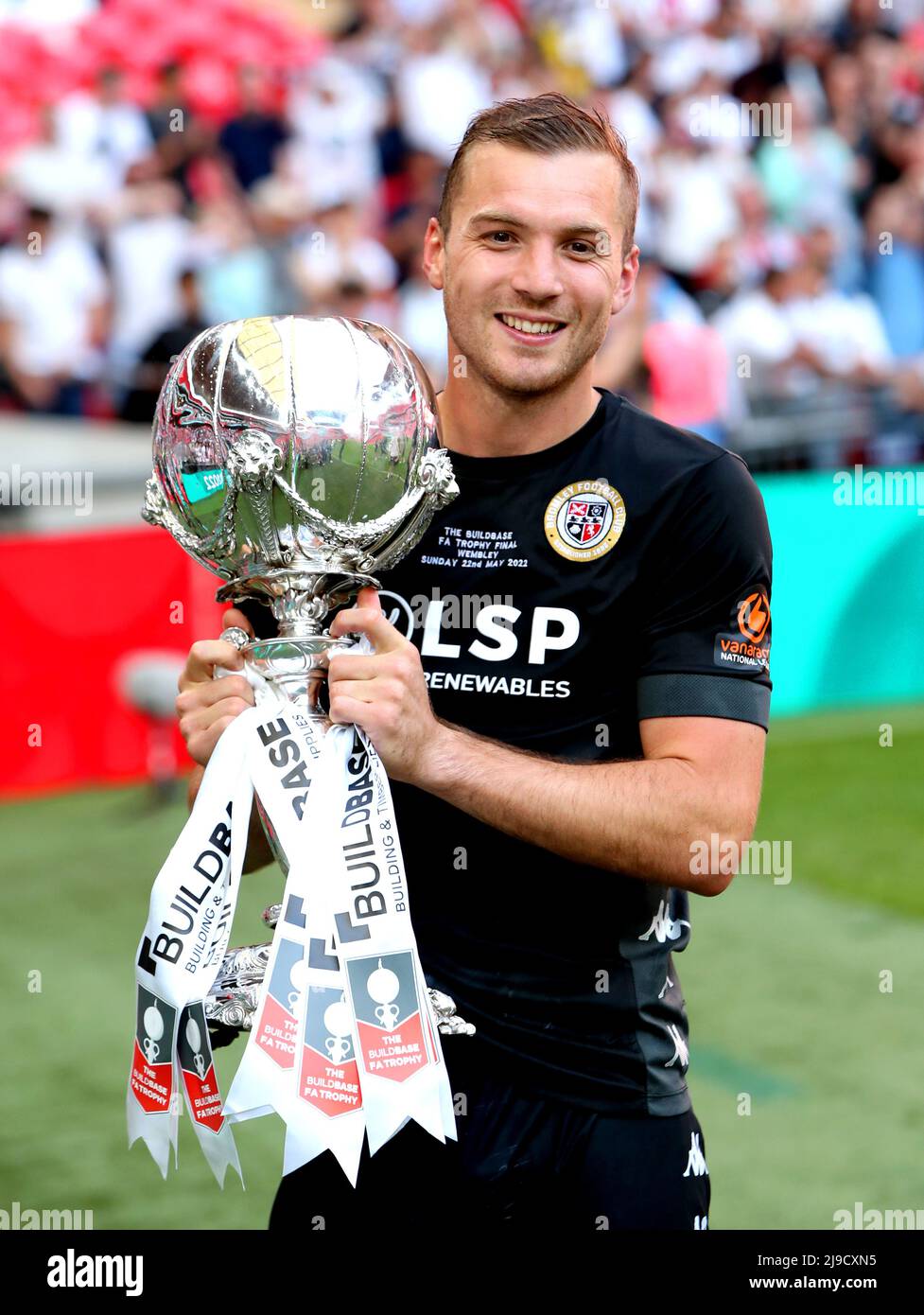 Bromley's Michael Cheek celebrates with the trophy after winning the ...