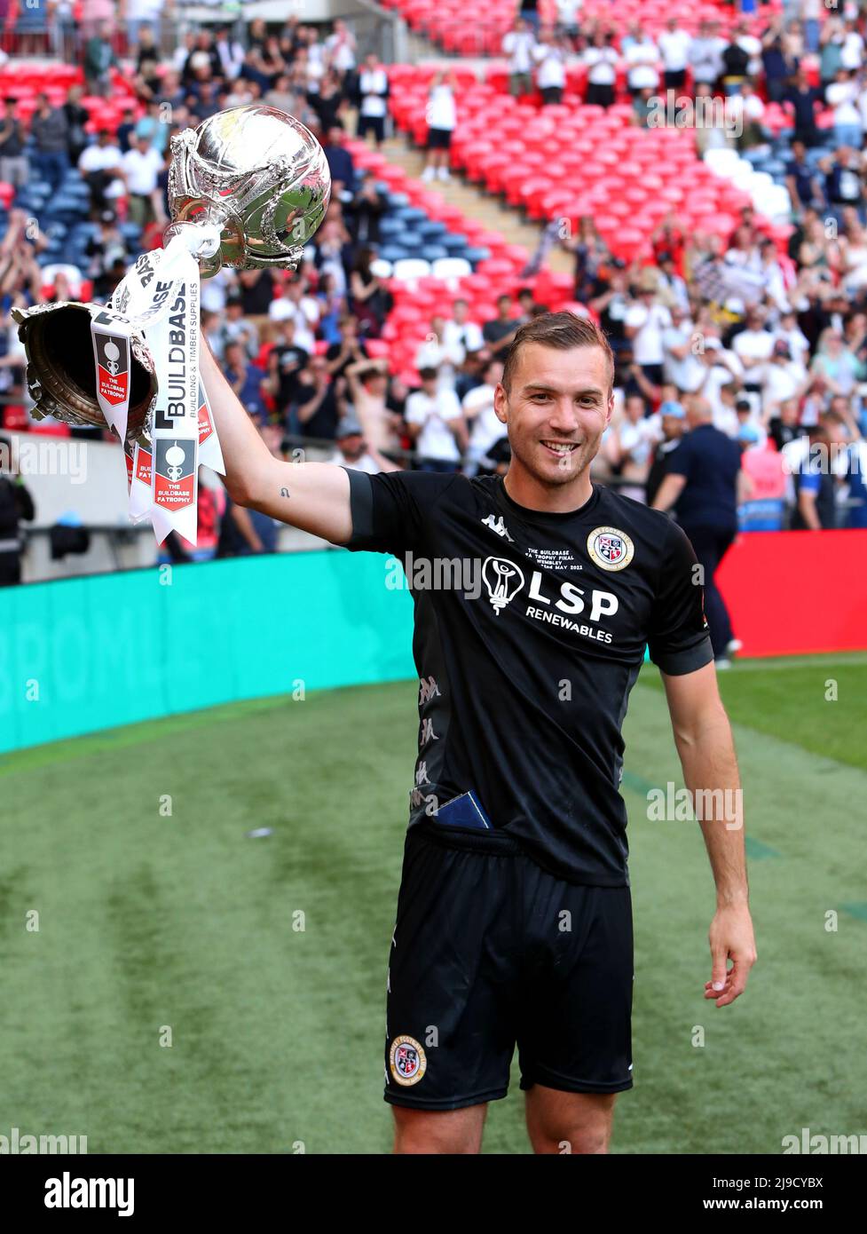Bromley's Michael Cheek celebrates with the trophy after winning the ...