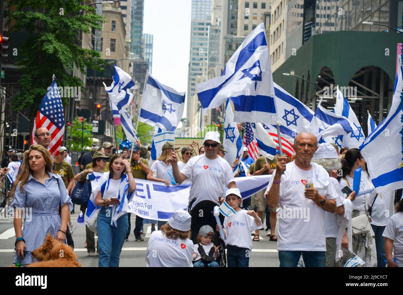 Participants are seen holding Israeli flags and marching during the ...