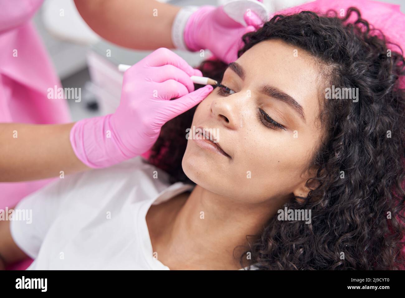 Doctor makes schematic dots with white pencil on female face Stock ...