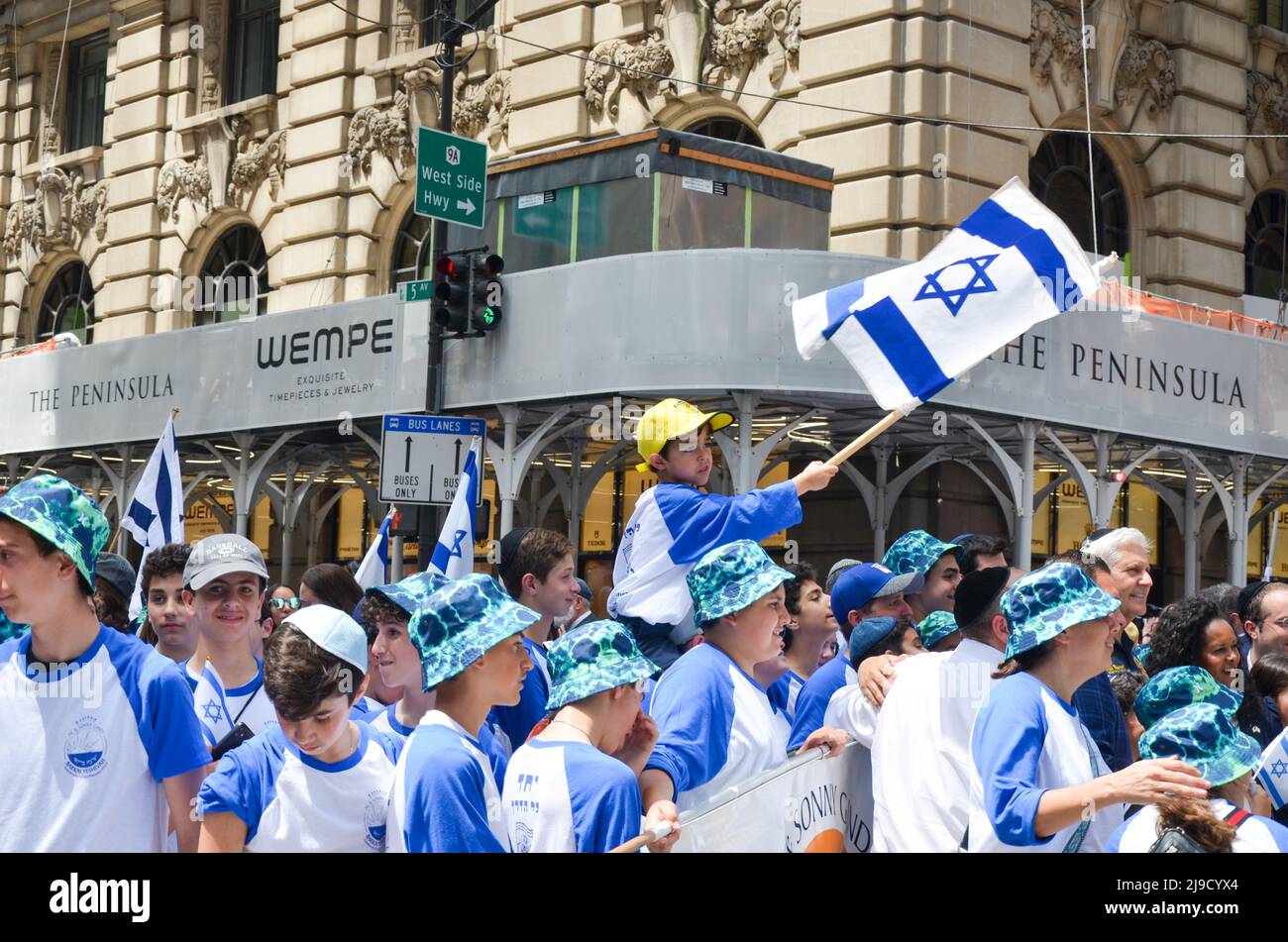 Young participant is seen holding Israeli flag and march way up Fifth ...