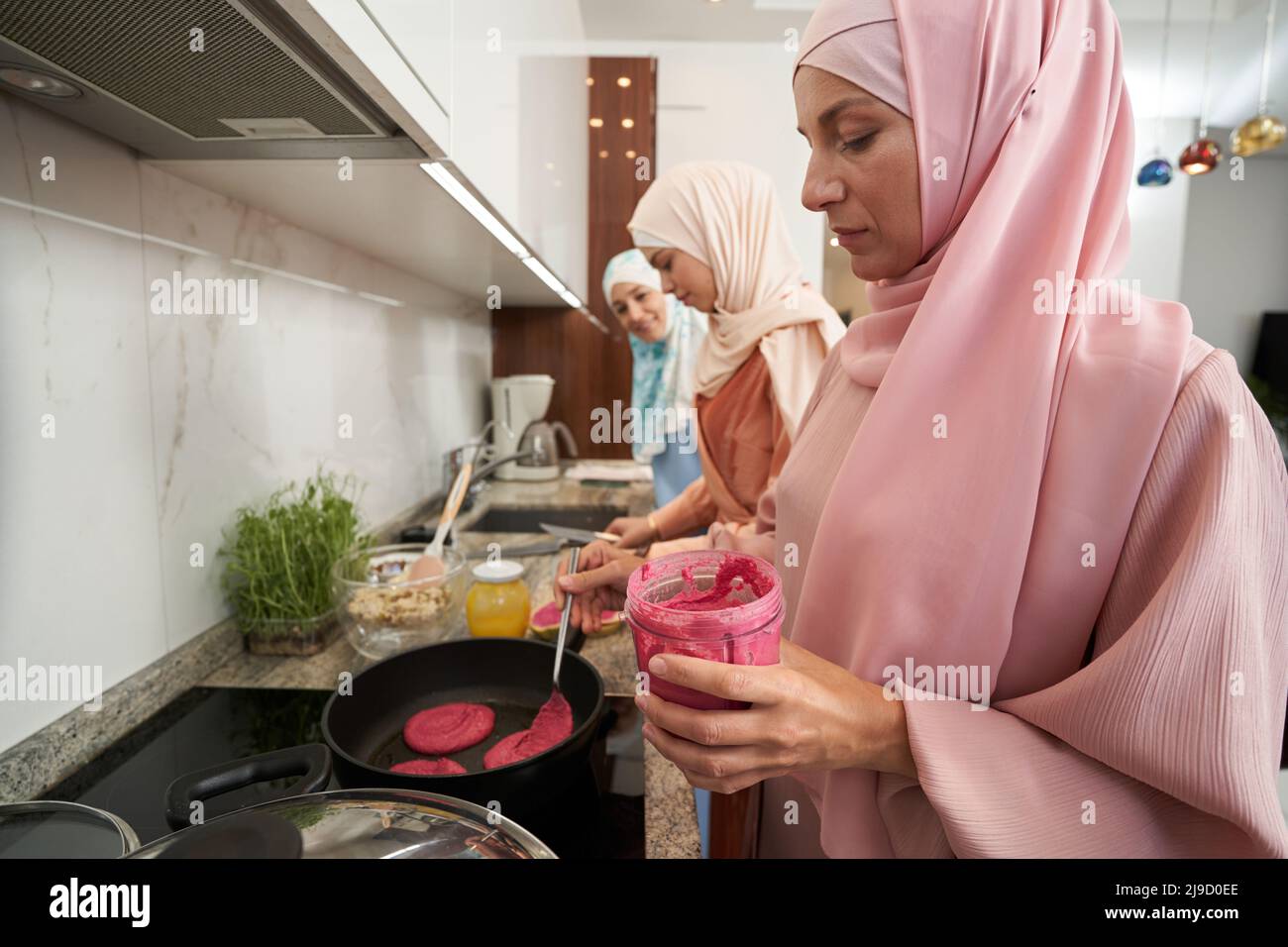 Muslim women preparing healthy food in kitchen Stock Photo - Alamy