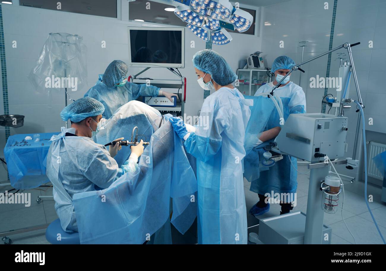 Four surgery specialist in operating theater treating patient Stock ...