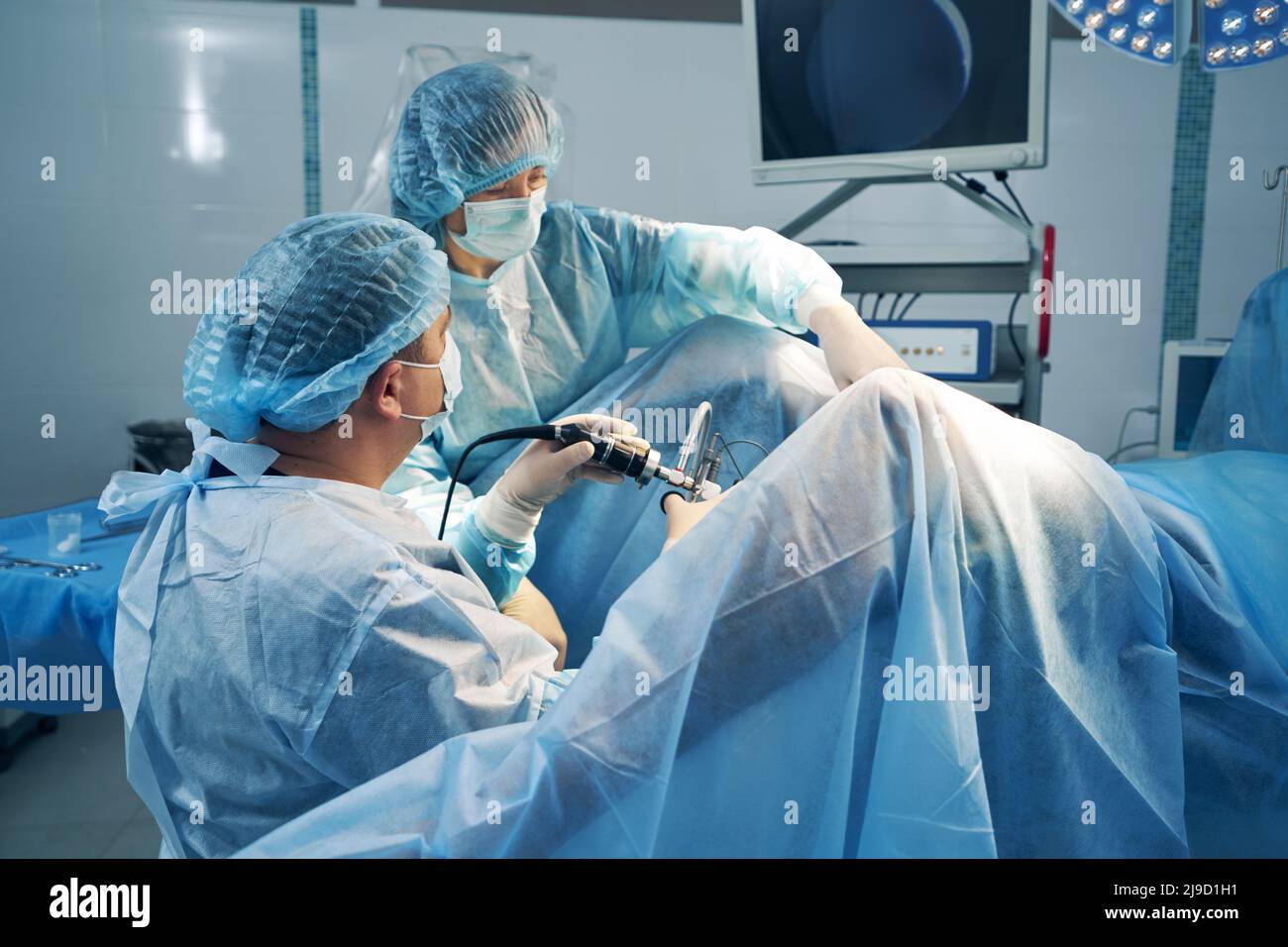 Surgeons using laparoscope during operation in pelvic area Stock Photo ...