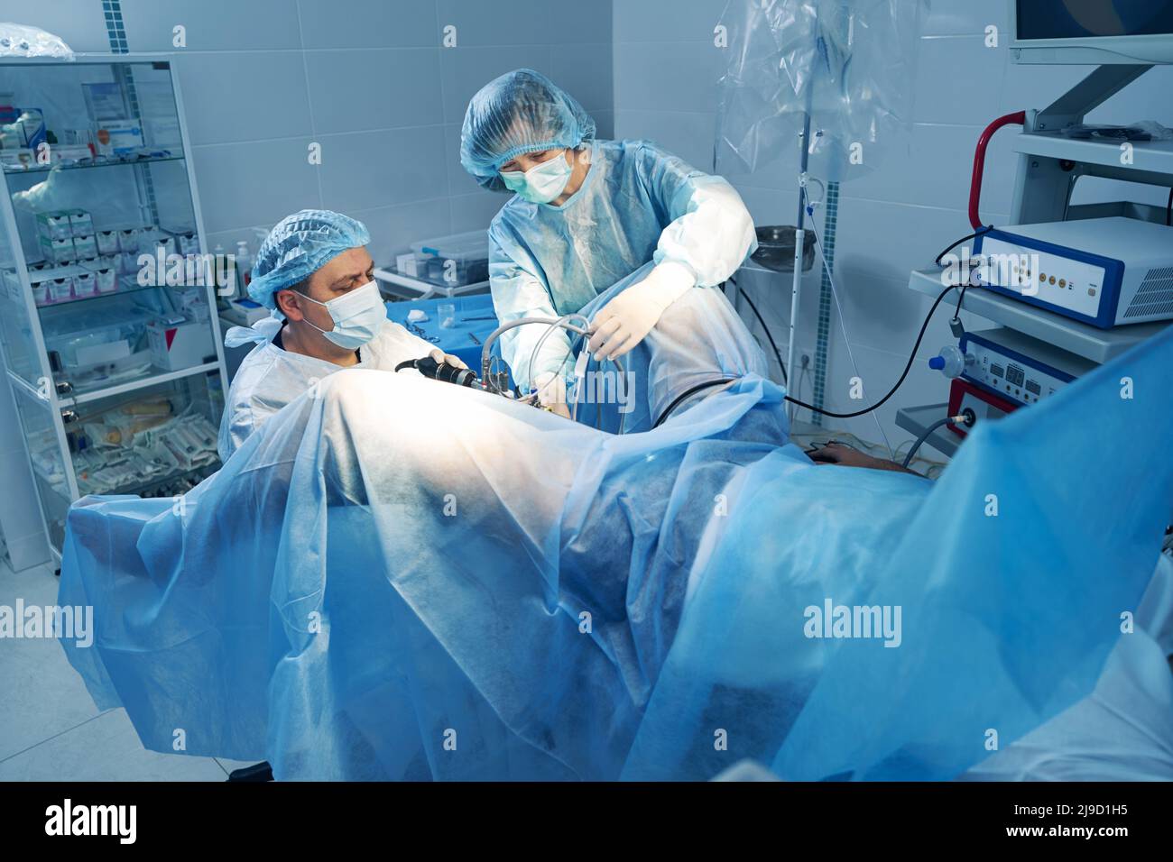 Nurse helping surgeon with laparoscopic camera control during operation ...