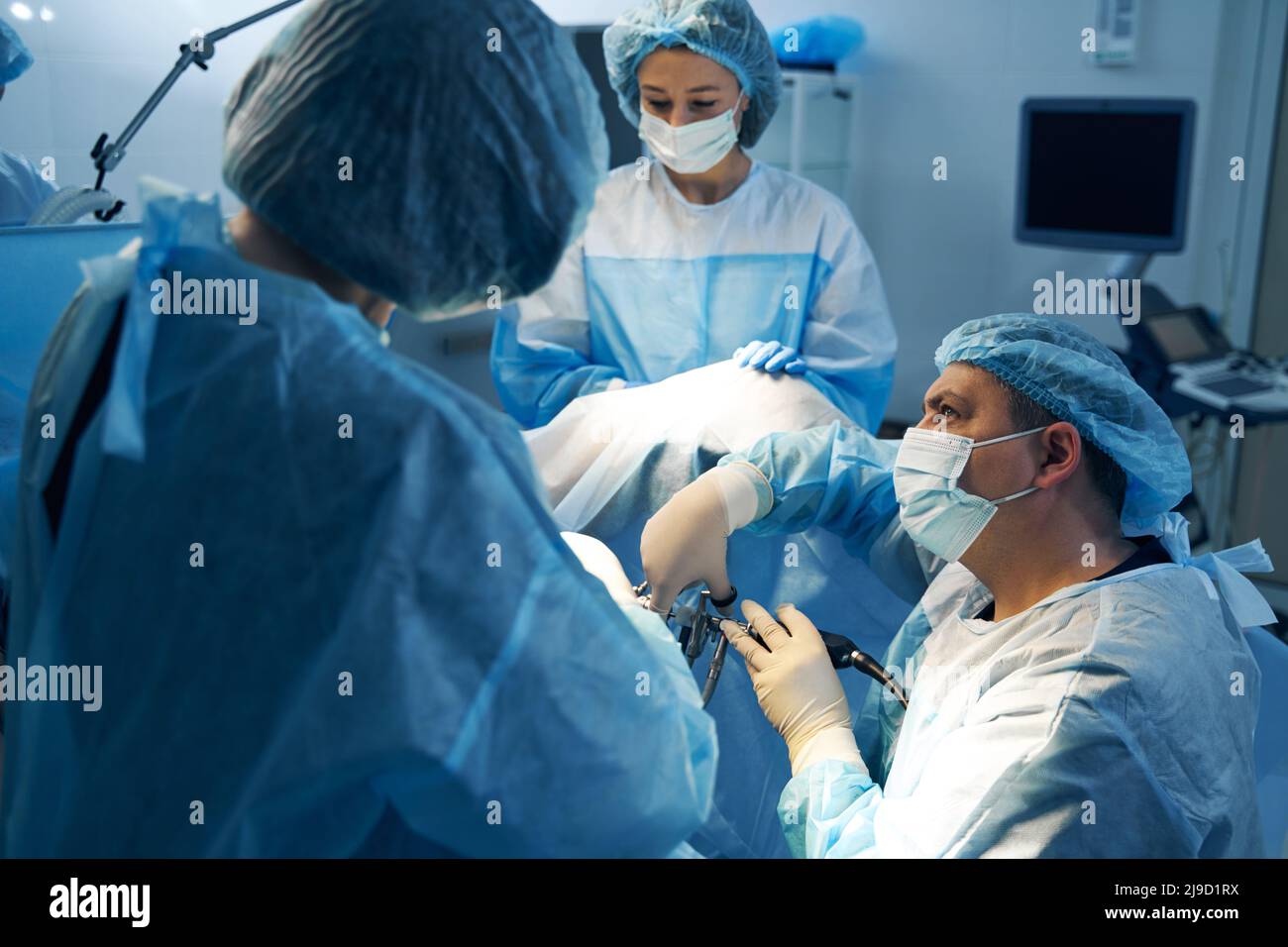 Surgeon with nurses doing operation with laparoscopic equipment Stock ...
