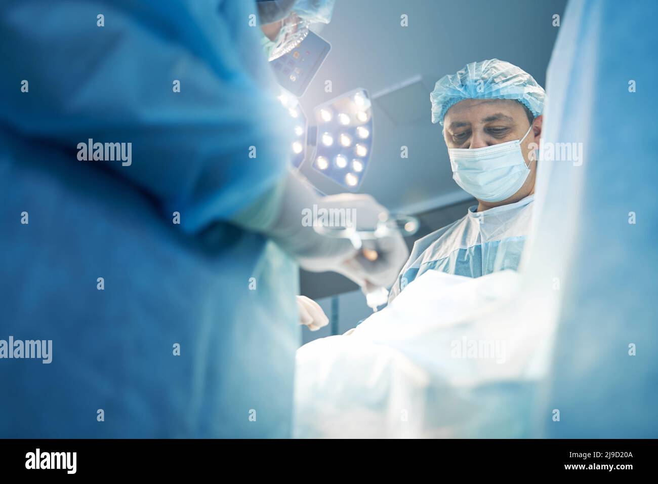 Concentrated surgeon working on abdomen operation in surgery room Stock ...
