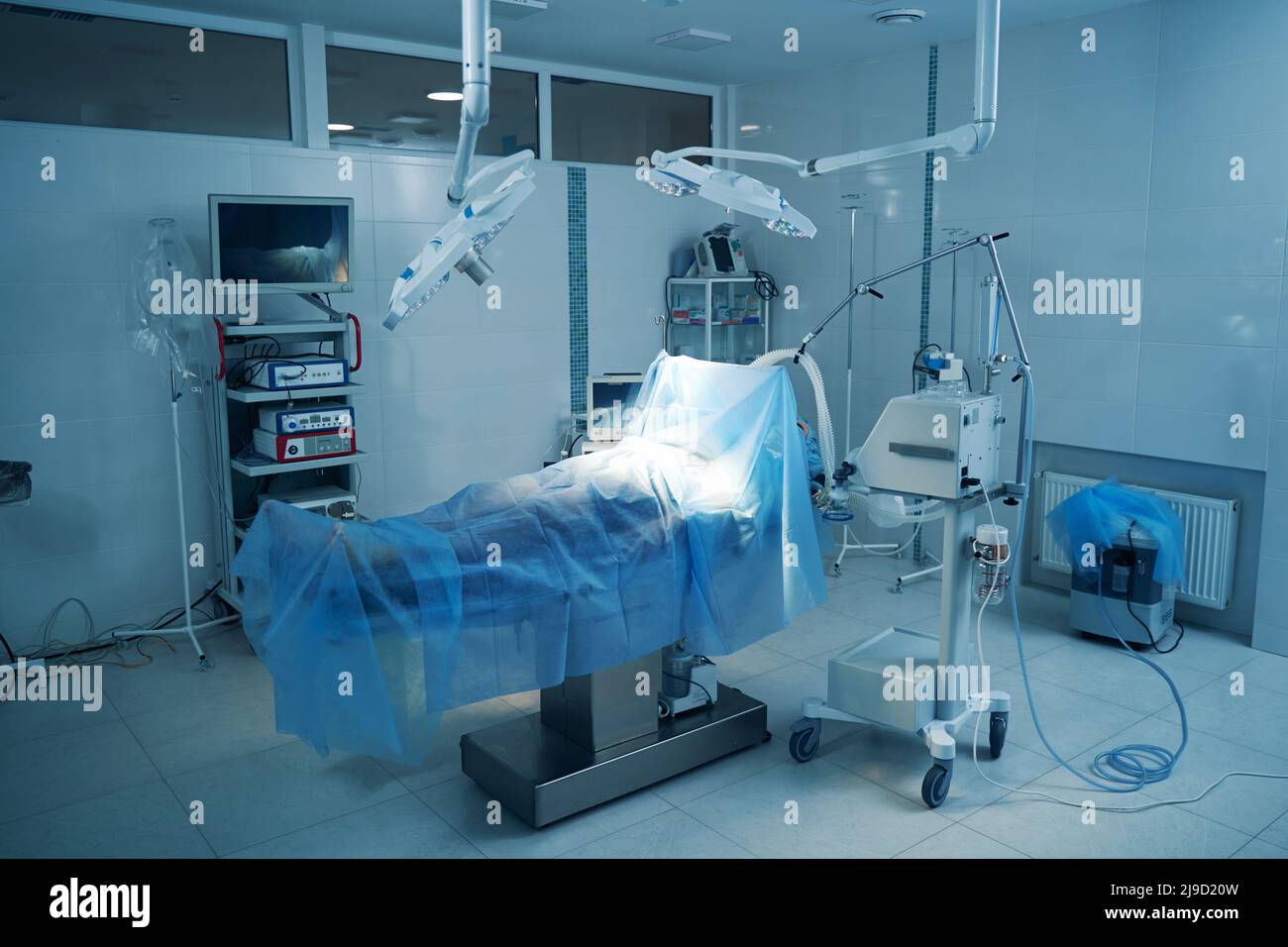 Empty operating room with patient lying under cover Stock Photo - Alamy