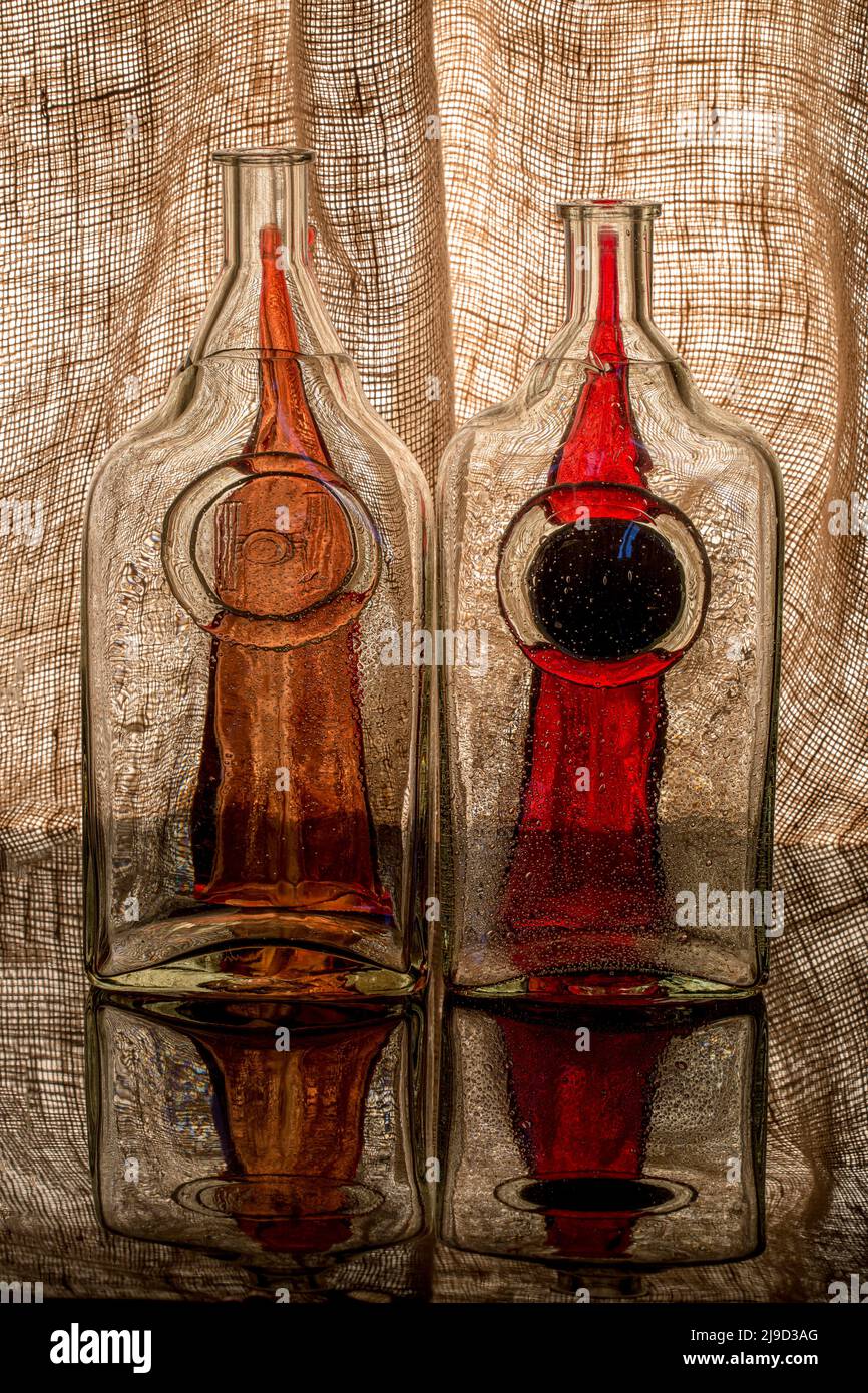 Still life with glass objects on a background of burlap Stock Photo - Alamy