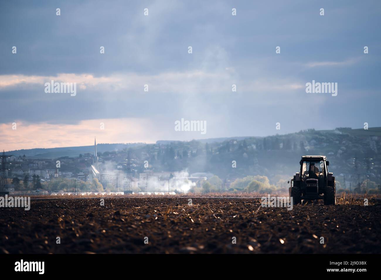Cultivated field, agronomy, farming concept. Farmer in tractor ...