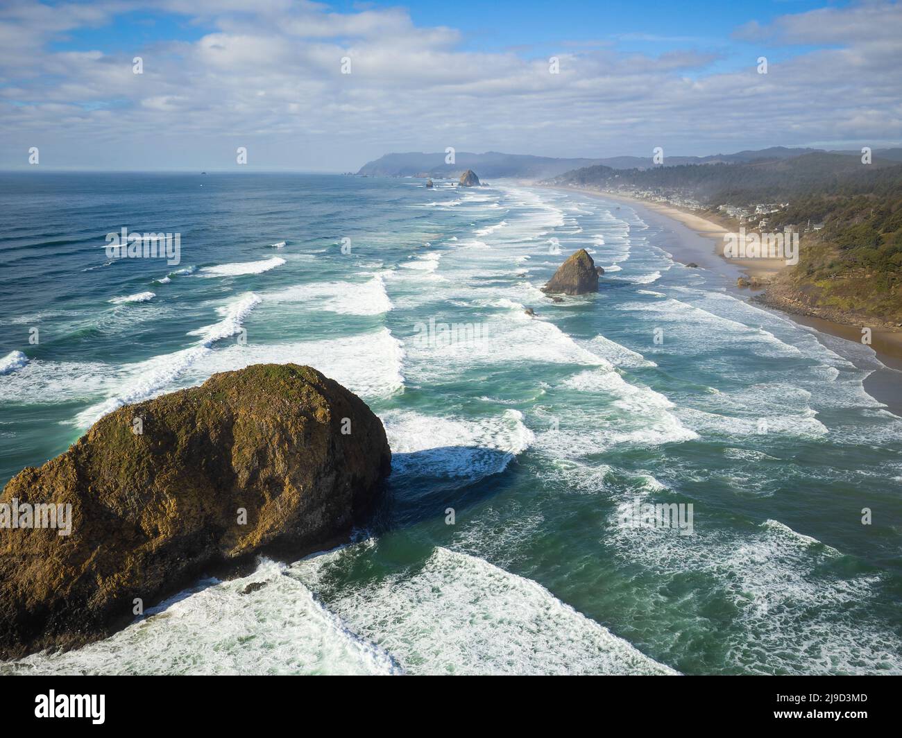 Picturesque sea landscape. A large boulder in the ocean, white foamy ...