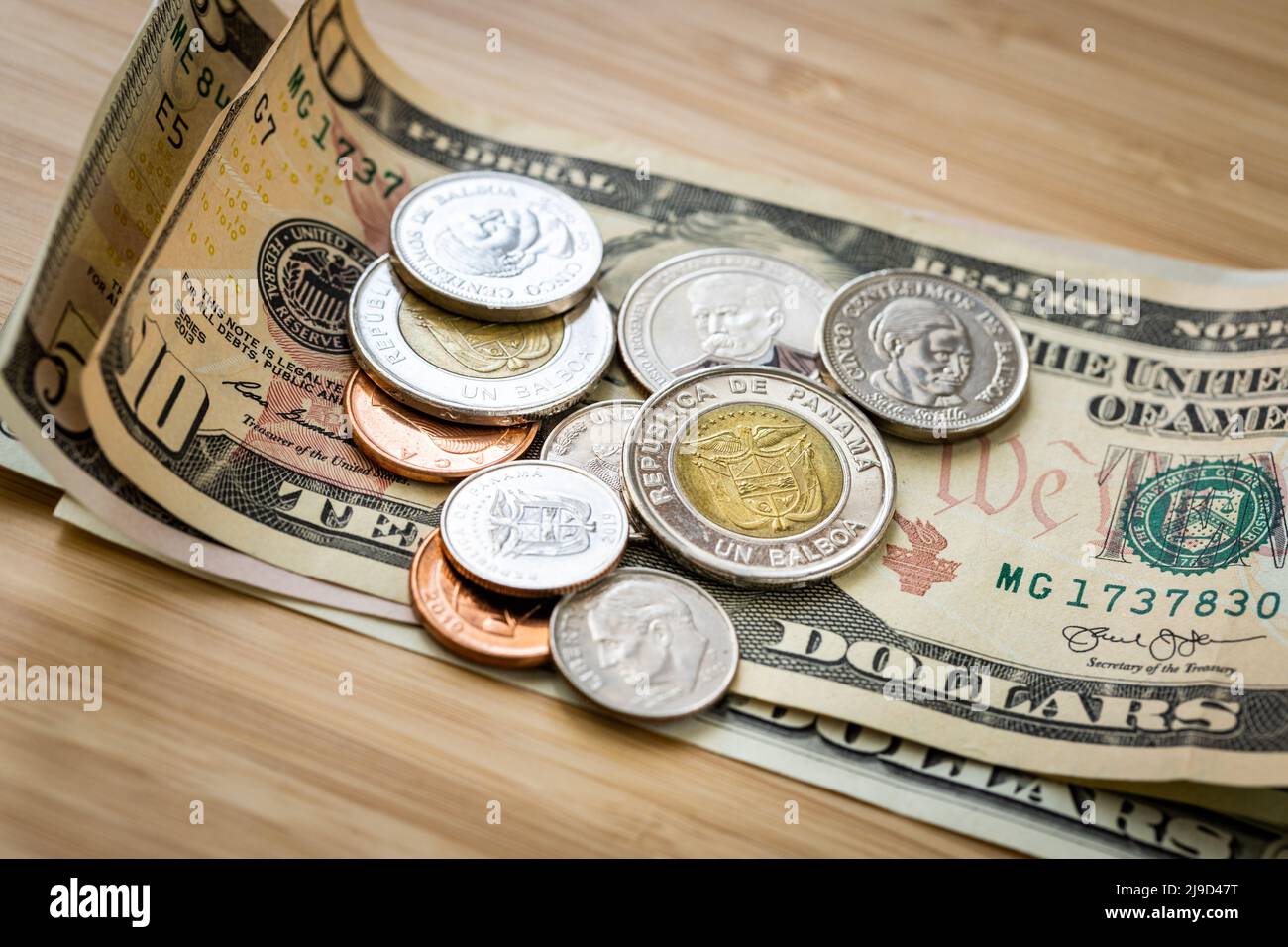 Panama money, folded American dollars lying on the table and coins ...