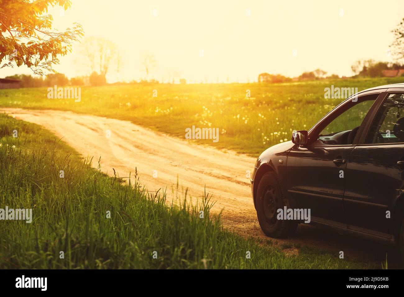 Dark blue car on country road by the green field. High quality photo ...