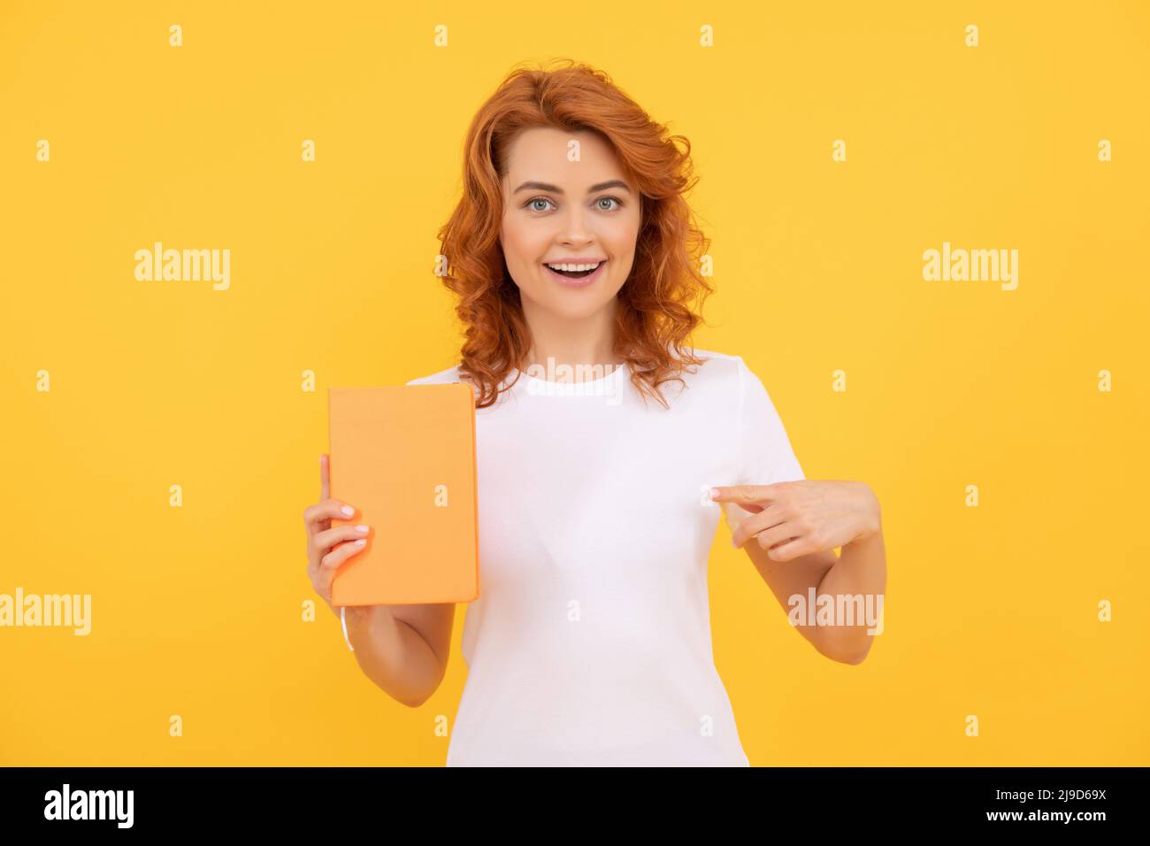 happy student on yellow background. girl study pointing finger on book ...