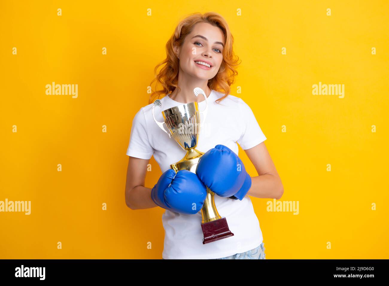 Woman in boxing gloves hold champion winner cup trophy. Winner female ...