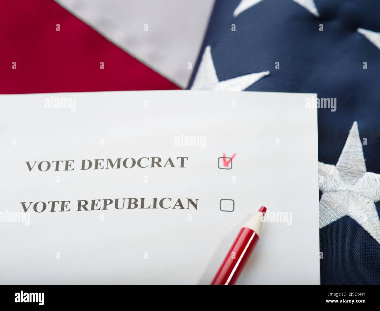 A check mark on the ballot against a Democrat and a red pencil against ...