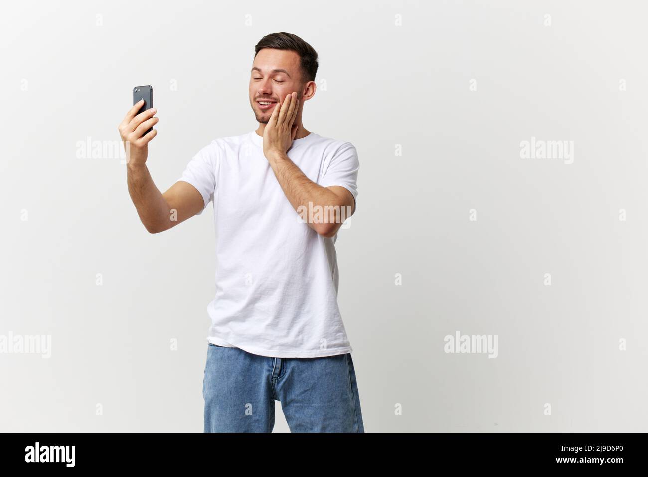 Cute happy tanned handsome man in basic t-shirt talk with family touch ...