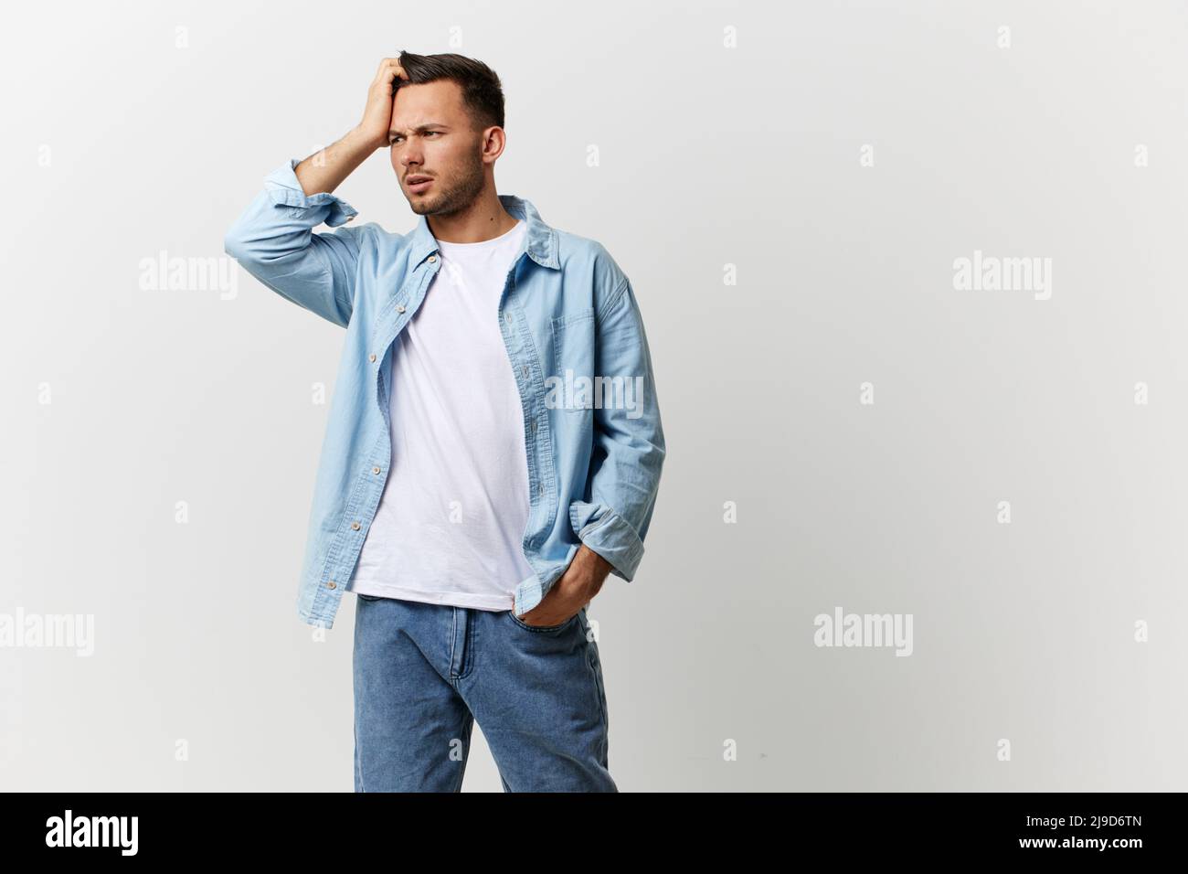 Unhappy frustrated pensive tanned handsome man in casual basic t-shirt ...
