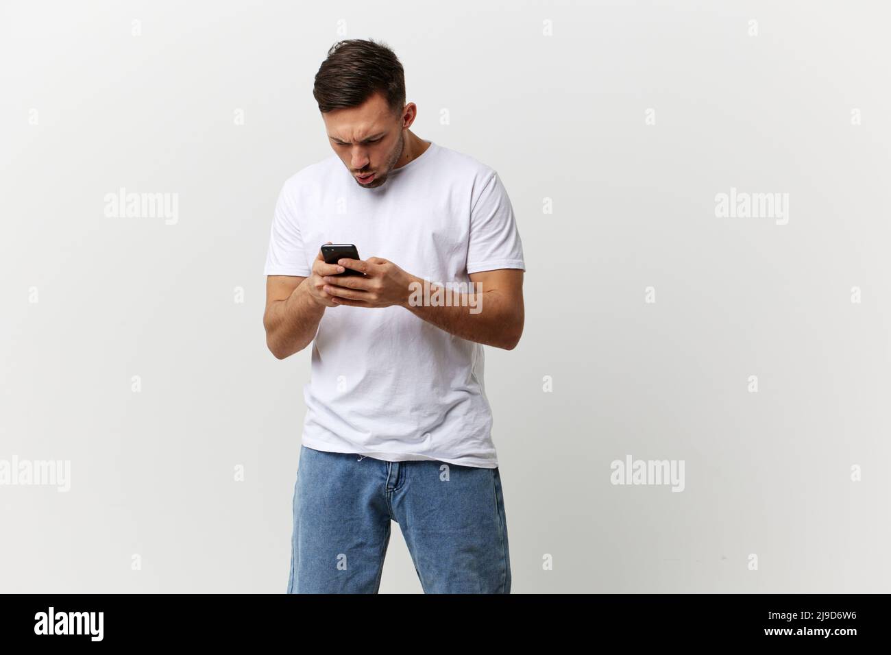 Angry confused irritated tanned handsome man in basic t-shirt type ...
