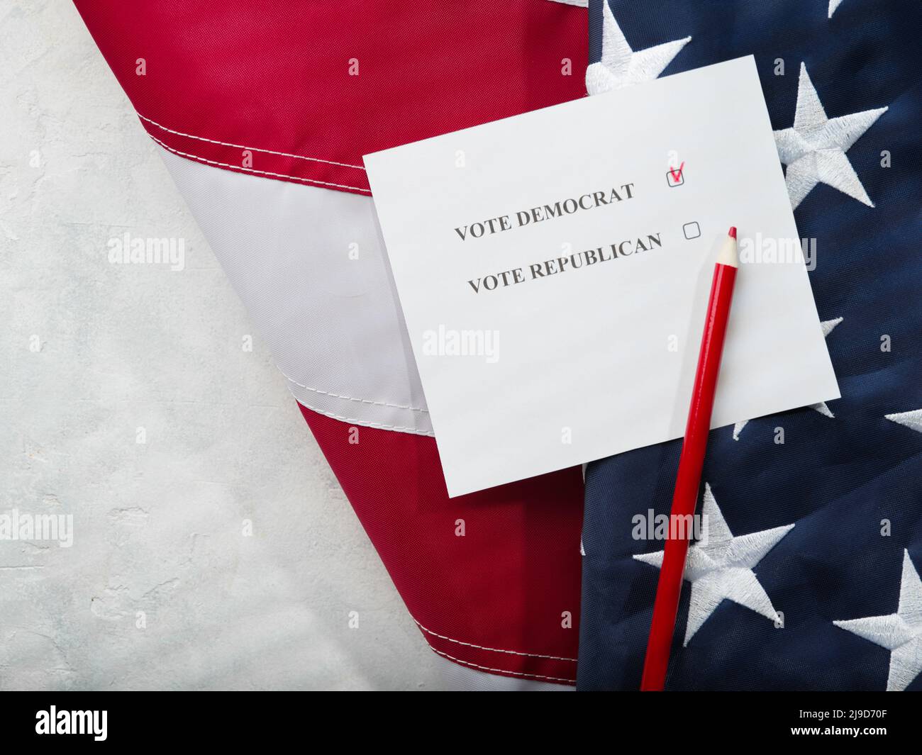 Voting ballot, red pencil on the background of the American flag ...