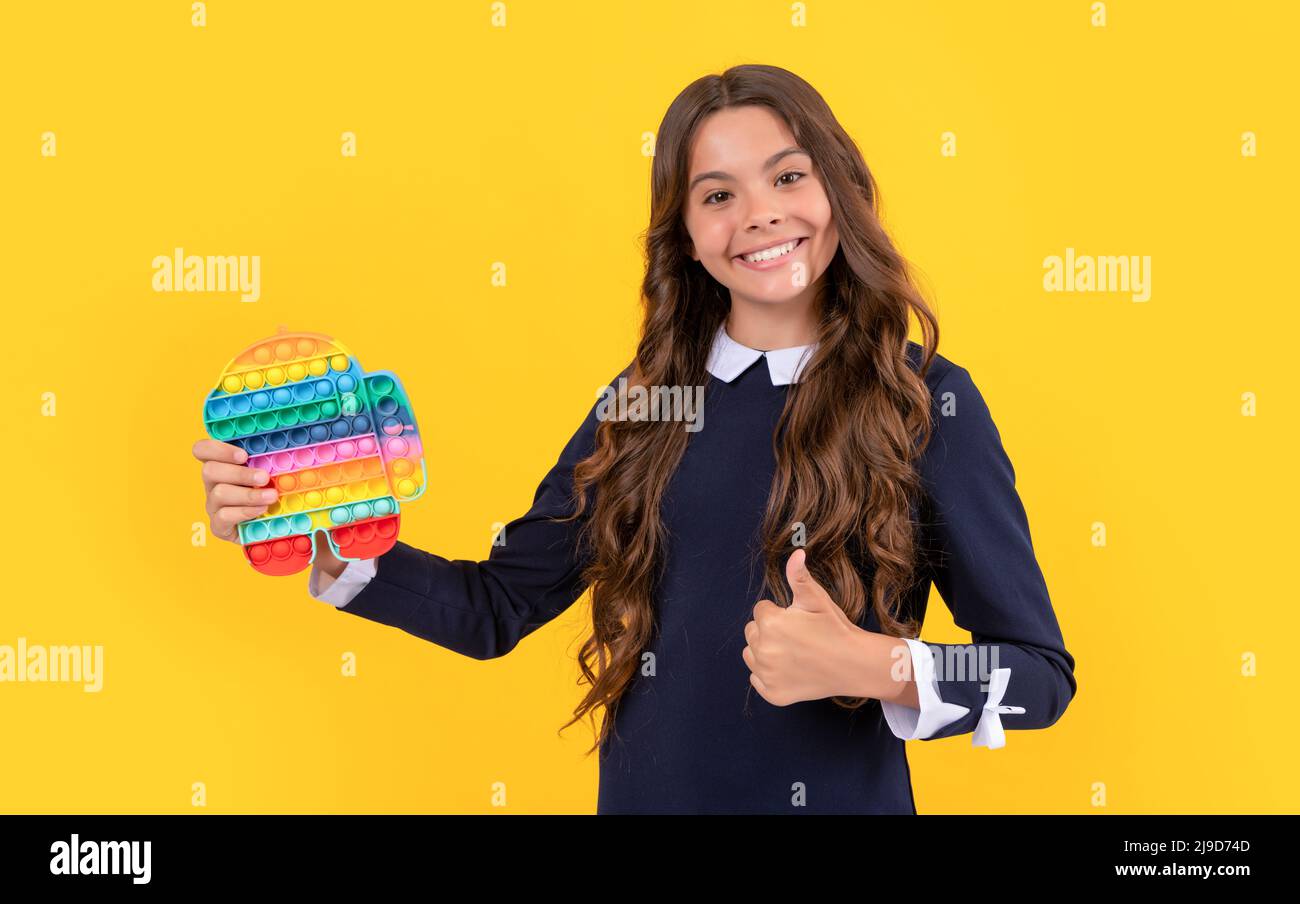 happy teen girl play with popit silicone sensory fidget toy with thumb ...