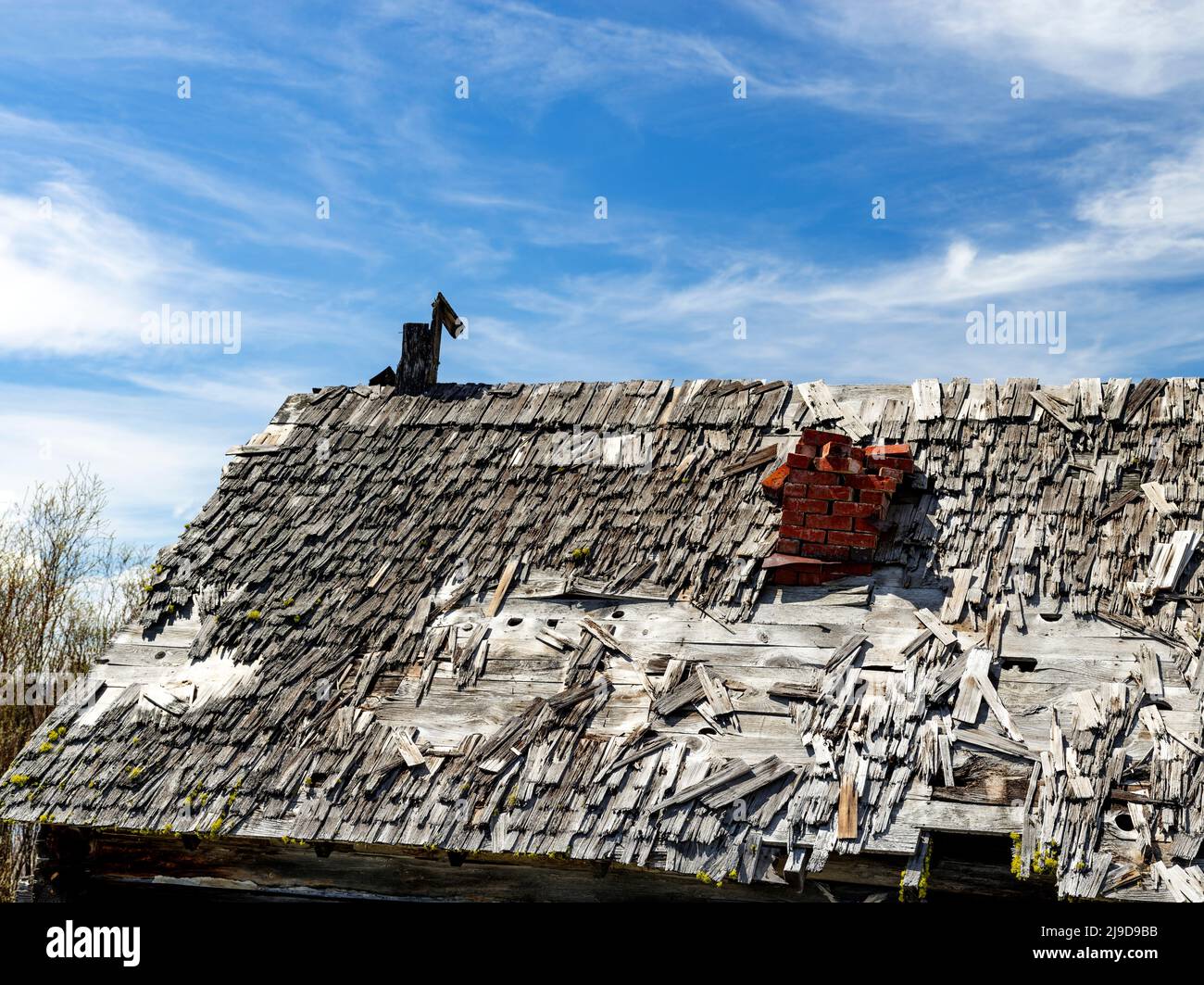 Brick chimney on an old dilapidated cabin roof with blue sky Stock ...
