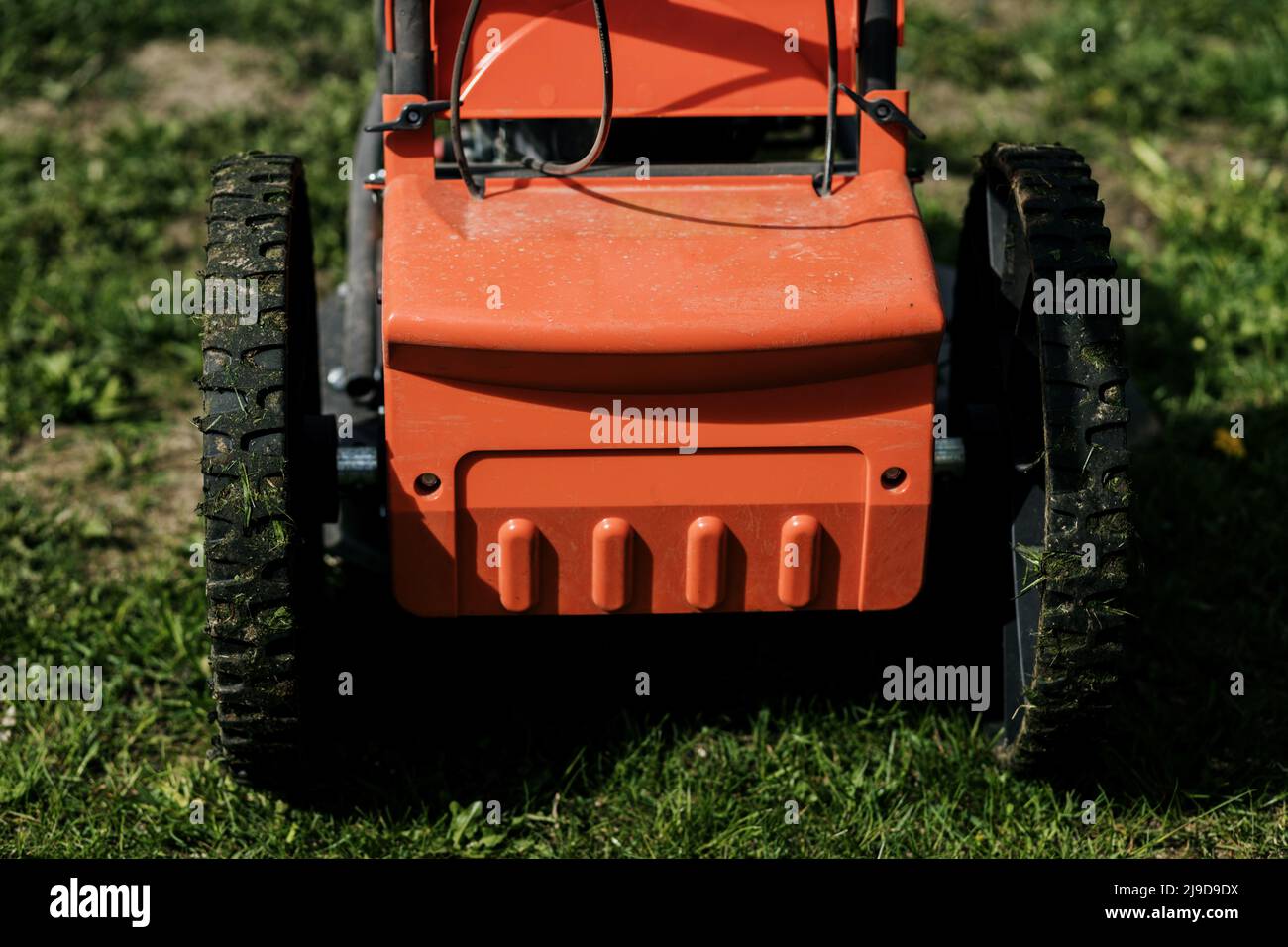 red lawn mower in green park in summer garden, care, work, tool Stock ...