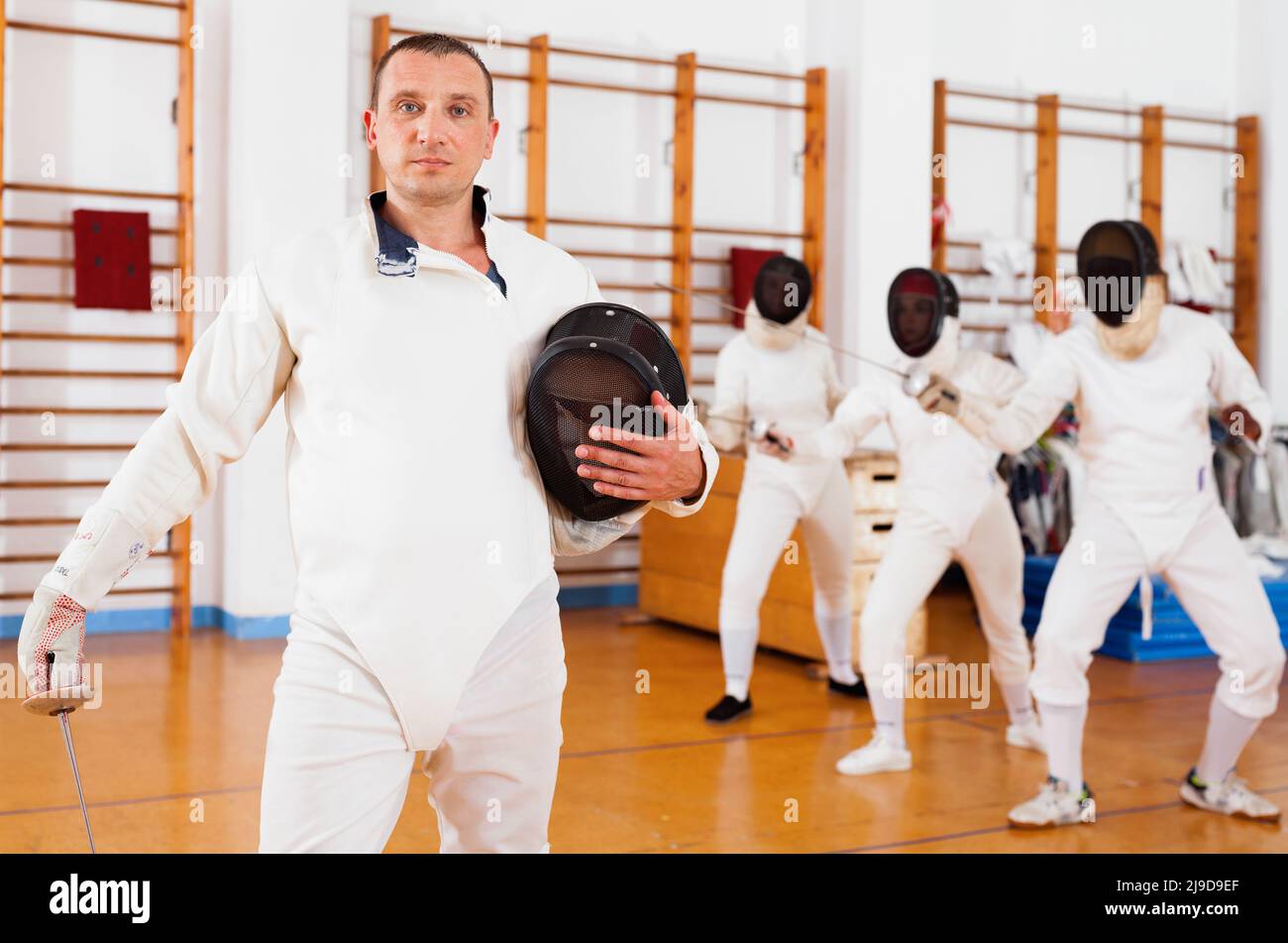 Active young glad cheerful positive smiling male fencer in uniform ...