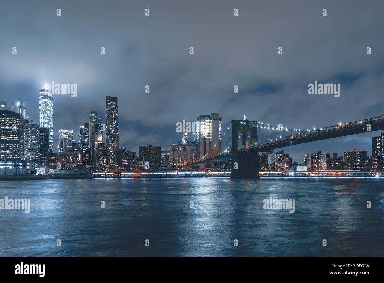 Brooklyn Bridge at Night with Water Reflection in New York City Stock ...