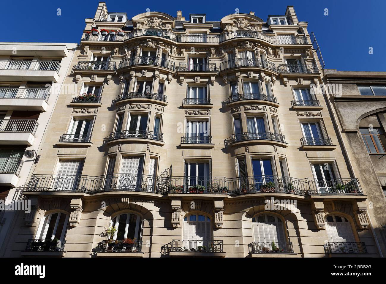 The facade of traditional French house with typical balconies and ...