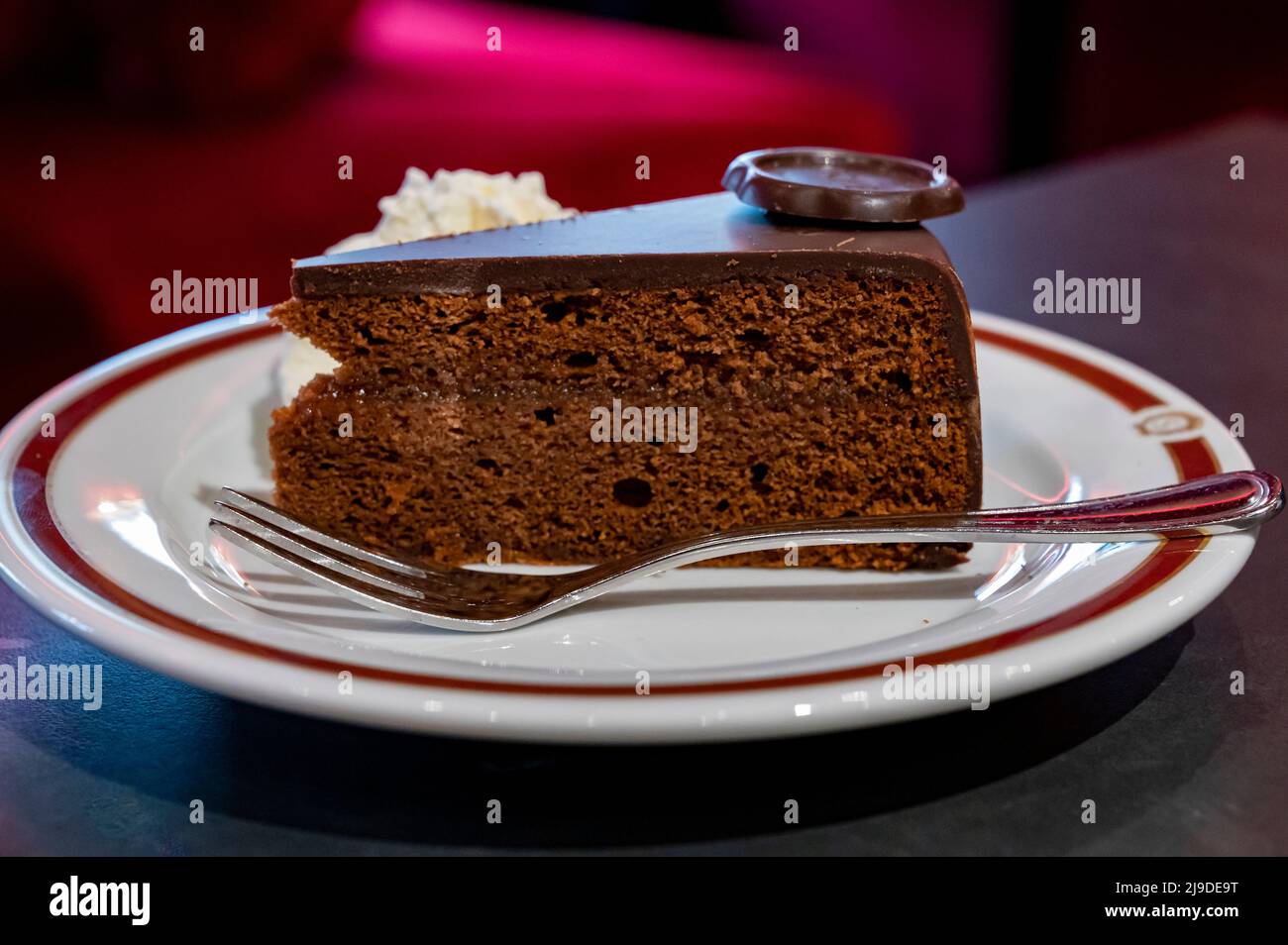 Piece of famous Sachertorte chocolate cake with apricot jam of Austrian ...