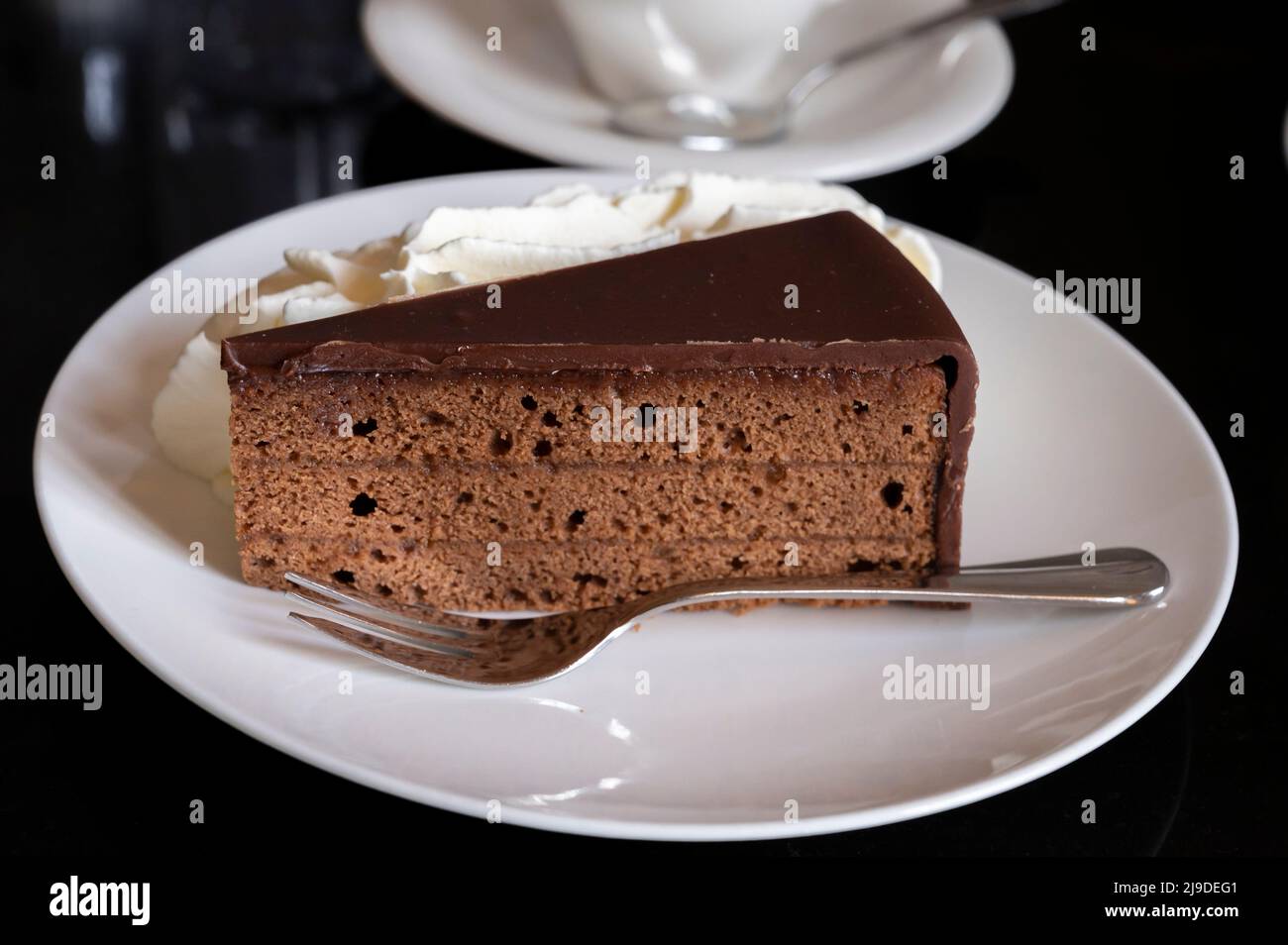 Piece of famous Sachertorte chocolate cake with apricot jam of Austrian ...