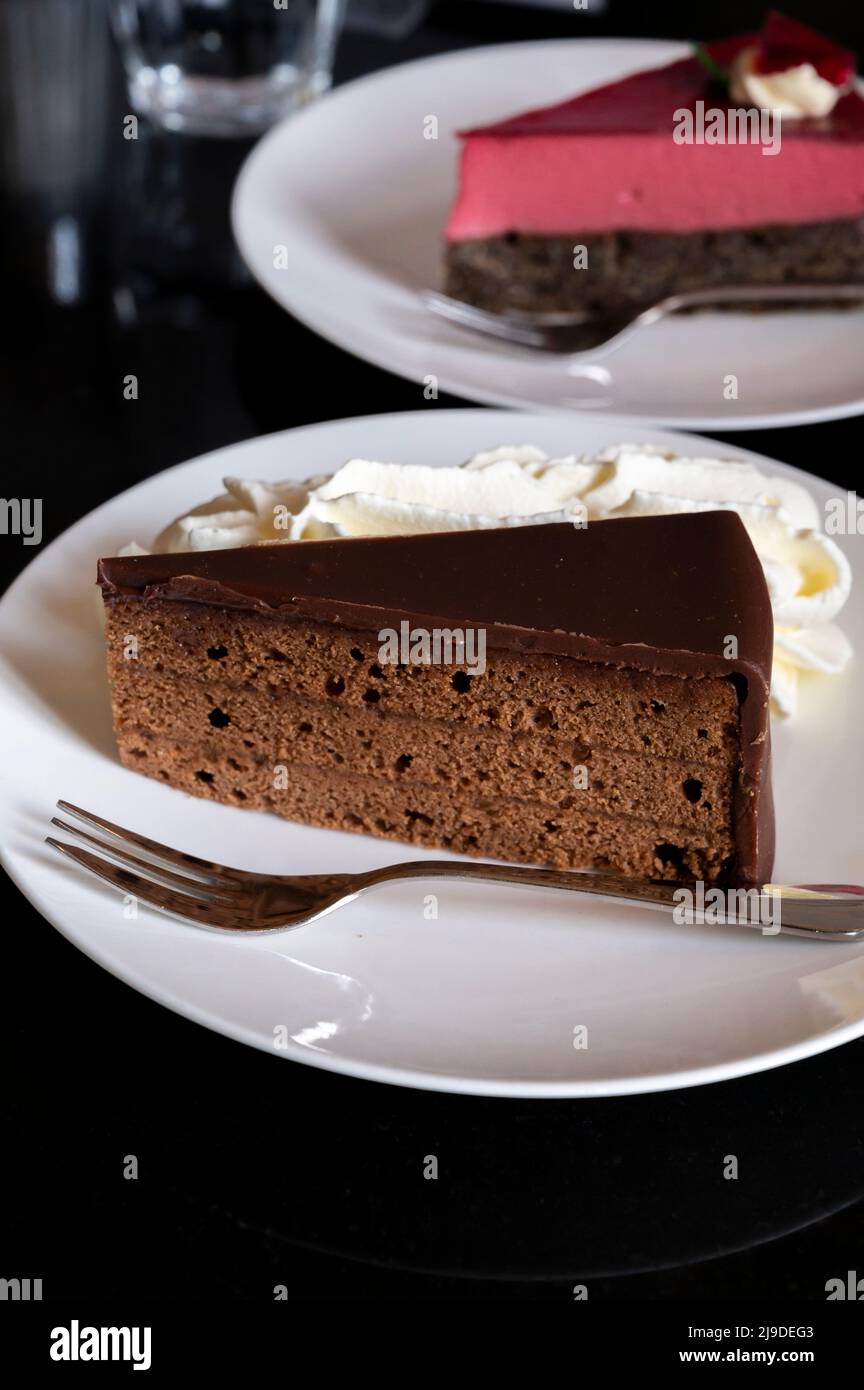 Piece of famous Sachertorte chocolate cake with apricot jam and Poppy ...