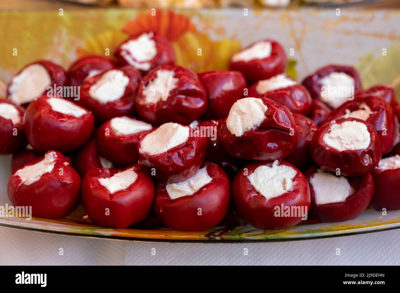 Mediterranean food, sweet red paprika pepper stuffed with soft white ...